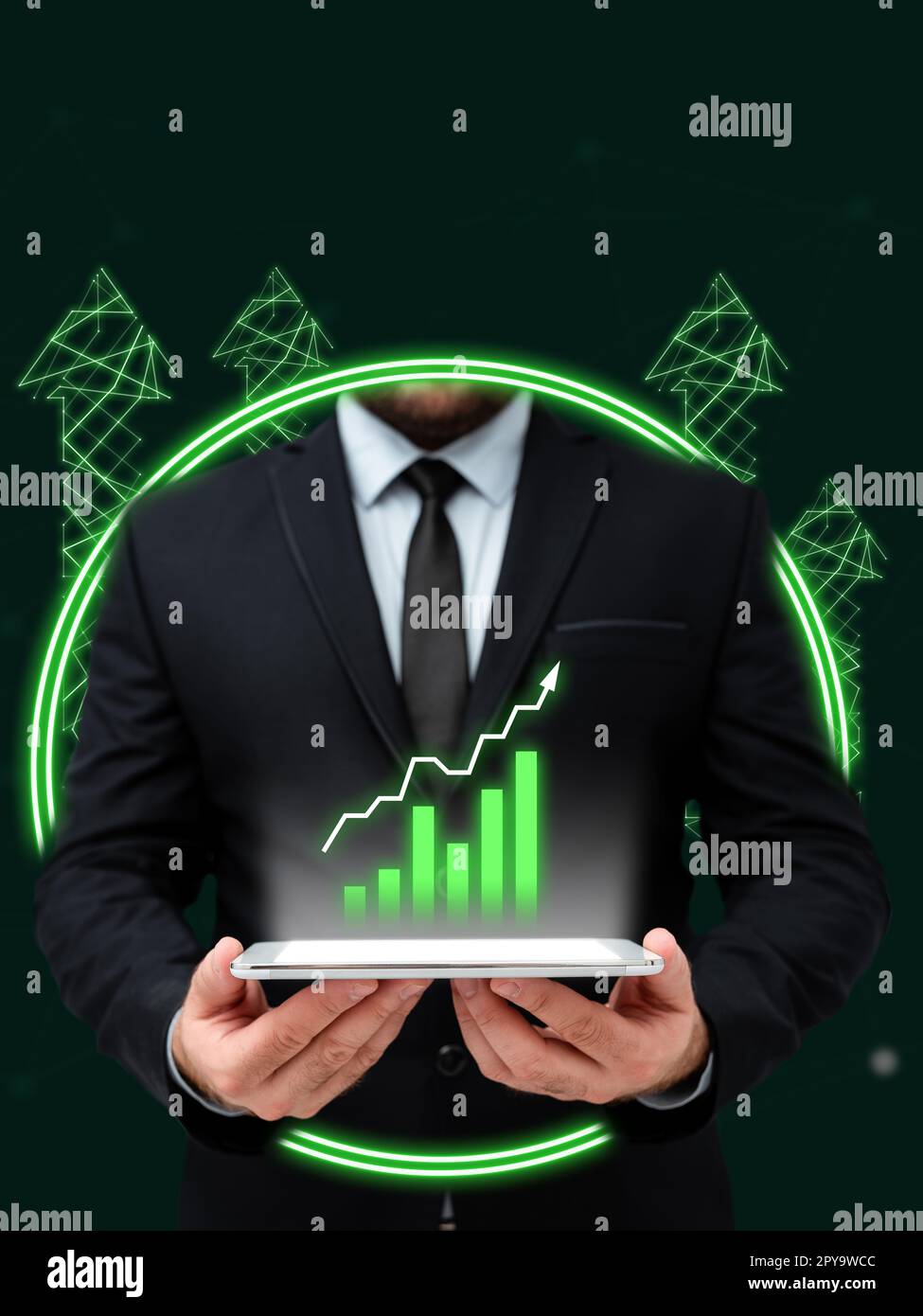 Businessman in black suit standing and holding tablet in two hands ...