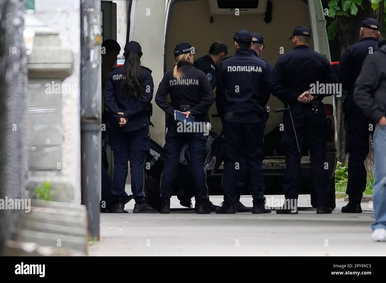 Bodies of victims are loaded into a van outside the Vladislav Ribnikar ...