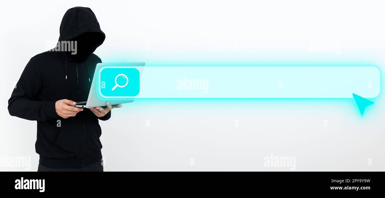 Male programmer in black hoodie stands and holds laptop. Hacker with ...