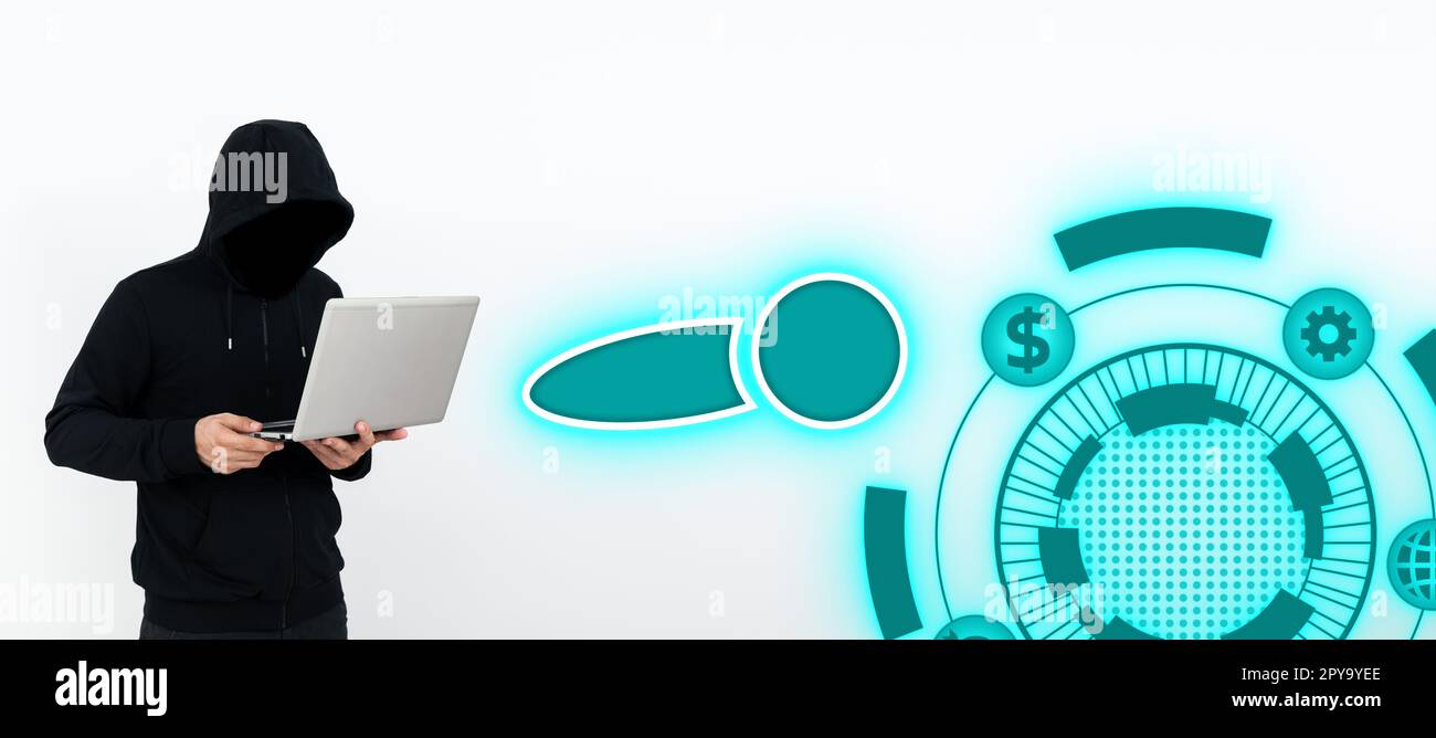 Male programmer in black hoodie stands and holds laptop. Hacker with ...