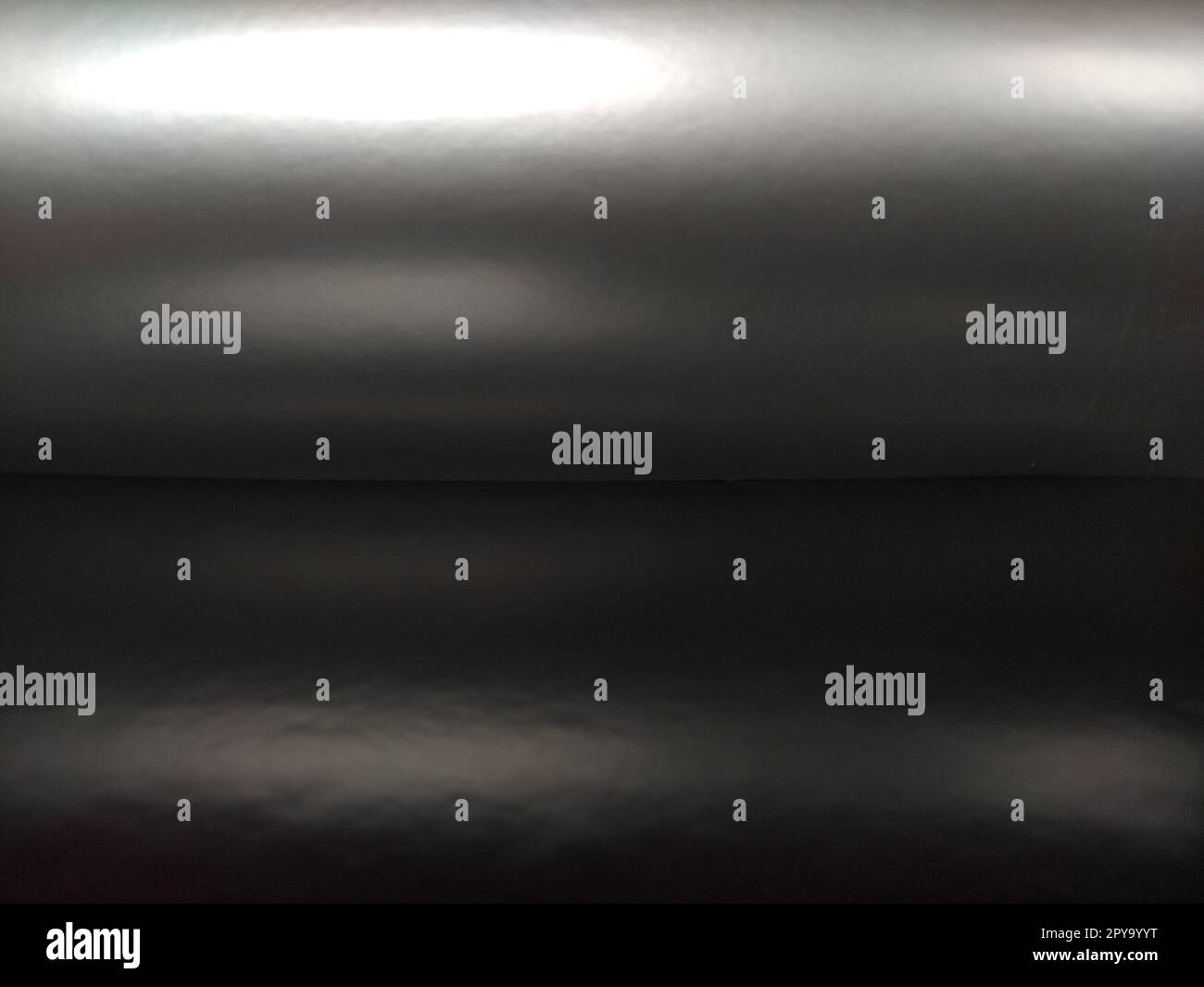 Gradient on a gray-black background. Horizontally folded shiny paper or ...