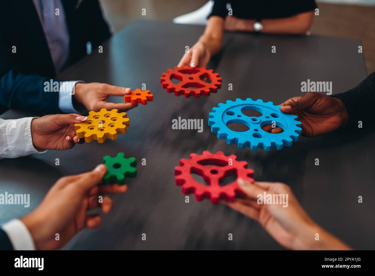 Businessman joining together gears hi-res stock photography and images ...