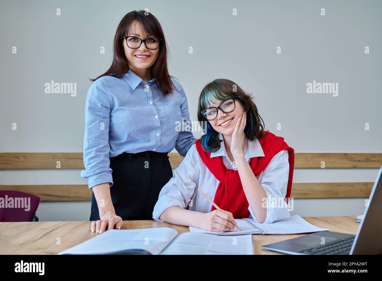 Young teenage female studying languages with teacher in classroom Stock ...