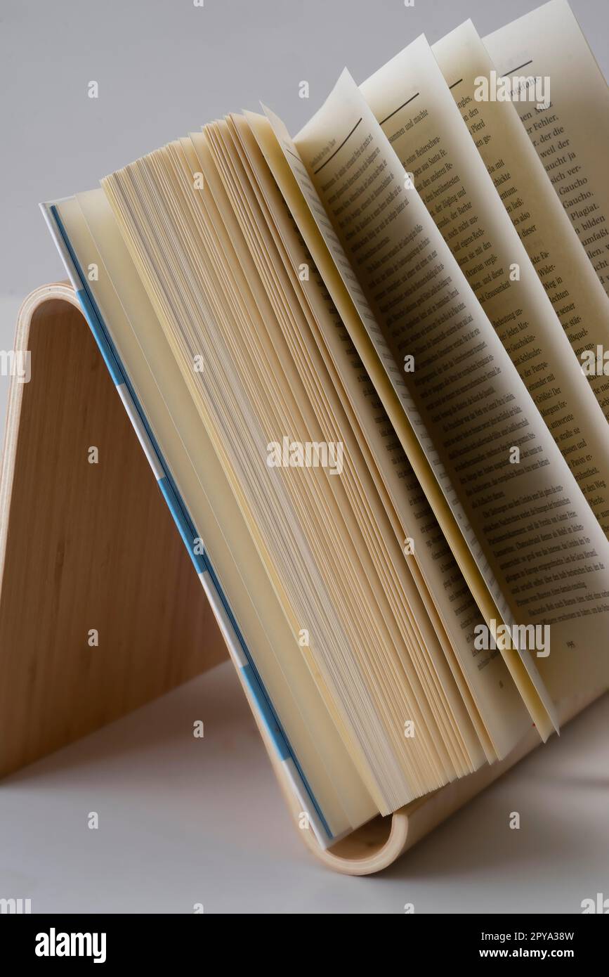 Book, open on wooden stand Stock Photo - Alamy