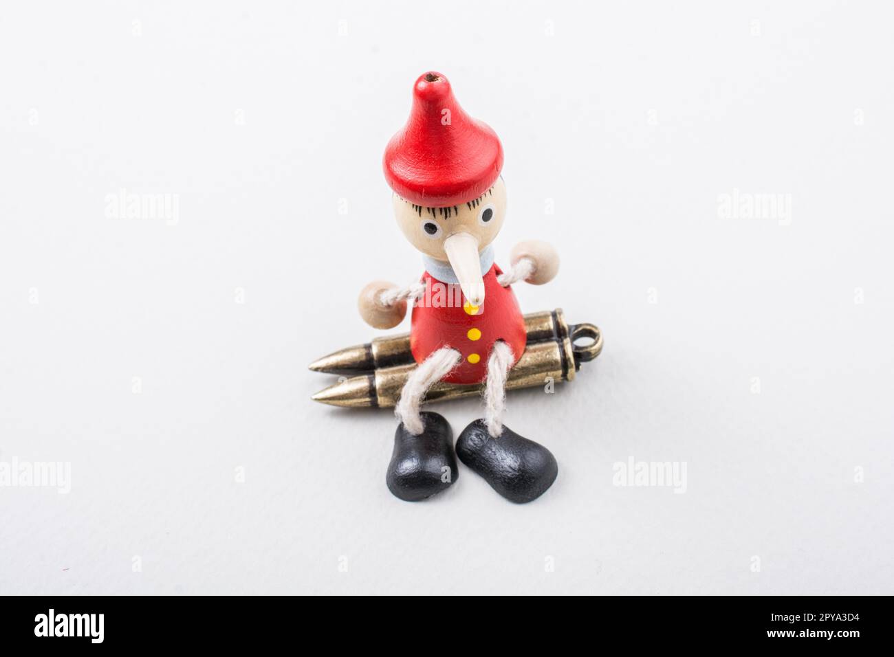 Bullet and wooden pinocchio doll with his long nose Stock Photo - Alamy