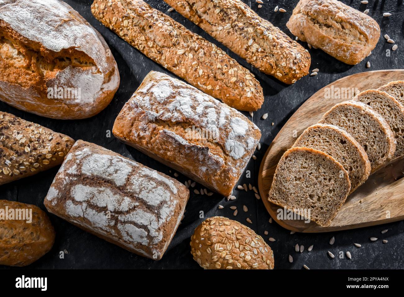 Assorted bakery products including loaves of bread and rolls Stock ...