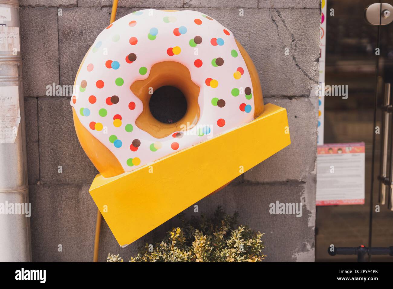 Giant donut sign in front of cafe or restaurant with empty copy space ...