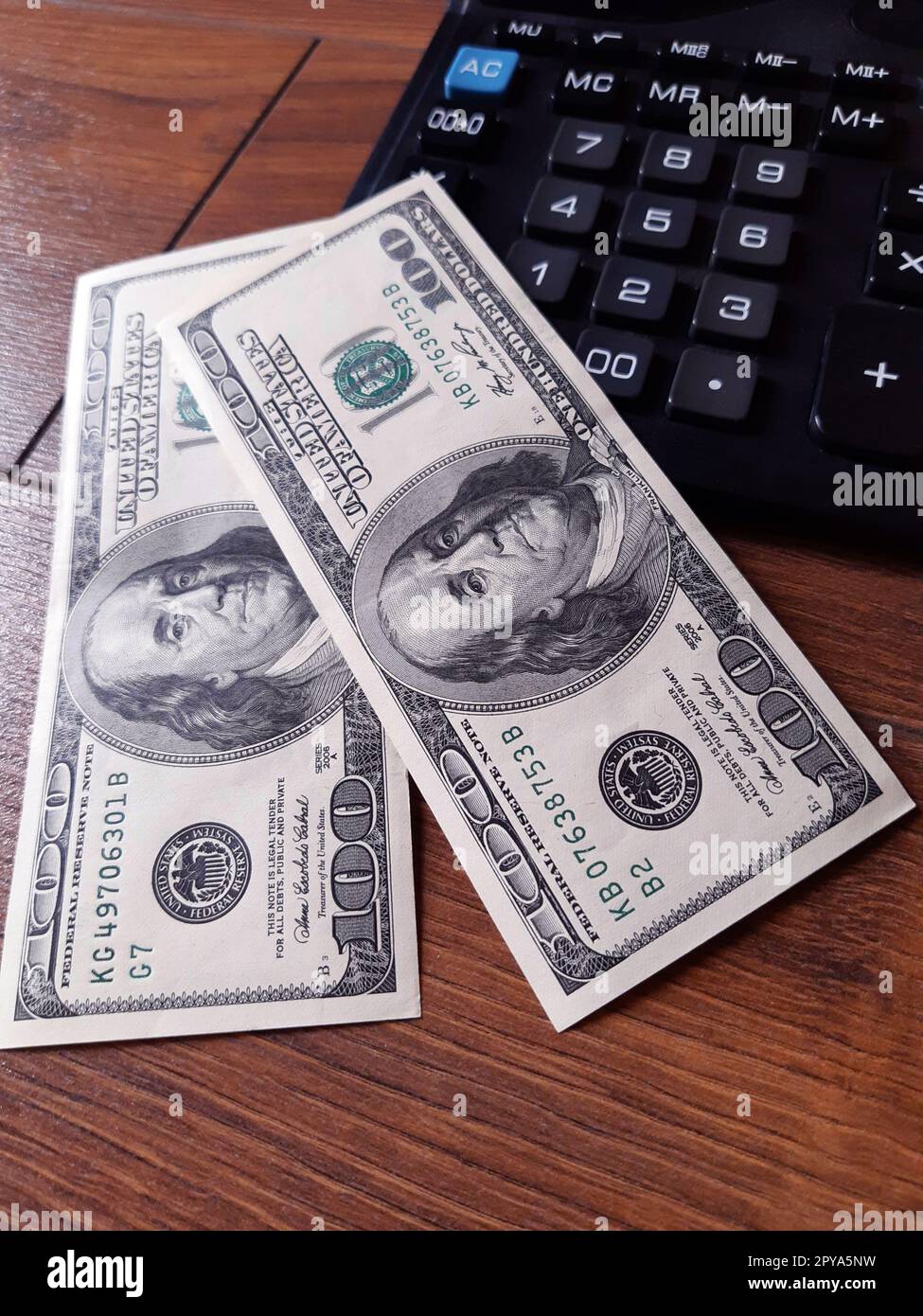 Money dollars and calculator on desktop Stock Photo - Alamy