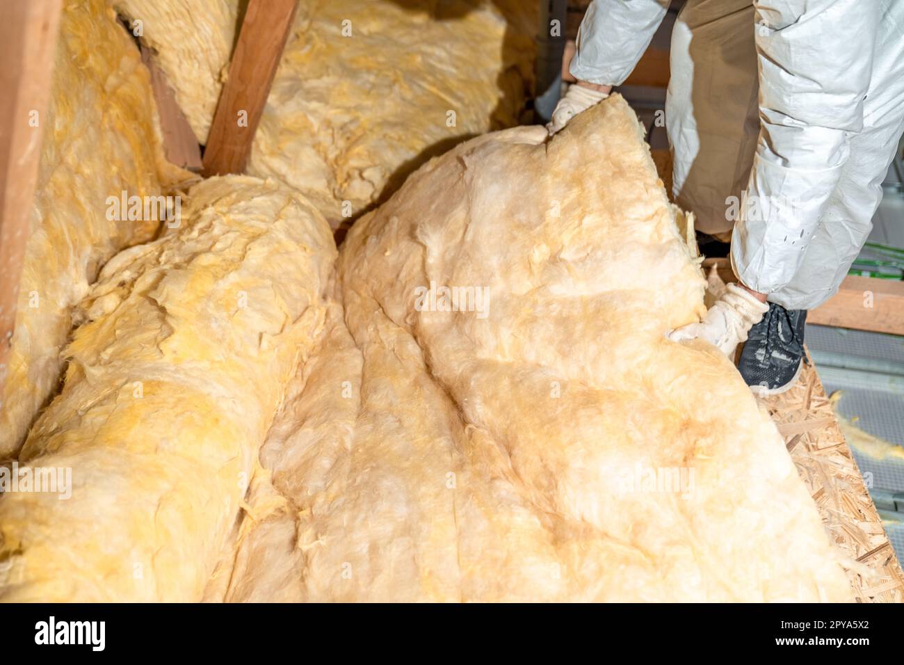 work on the attic of the house, insulated with glass wool Stock Photo ...