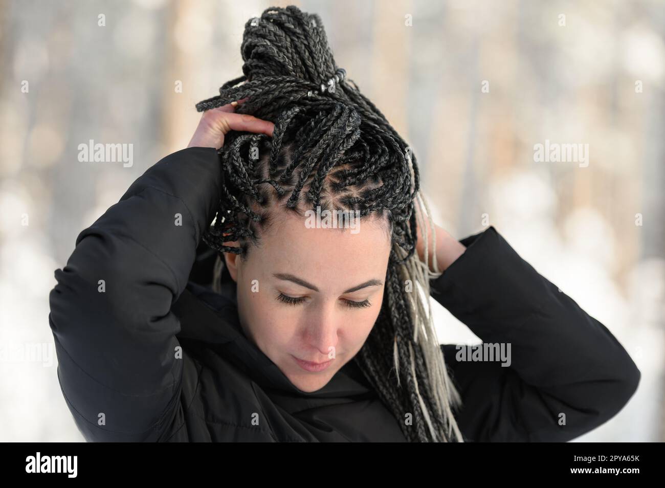Young woman with African braids in natural winter environment landscape ...