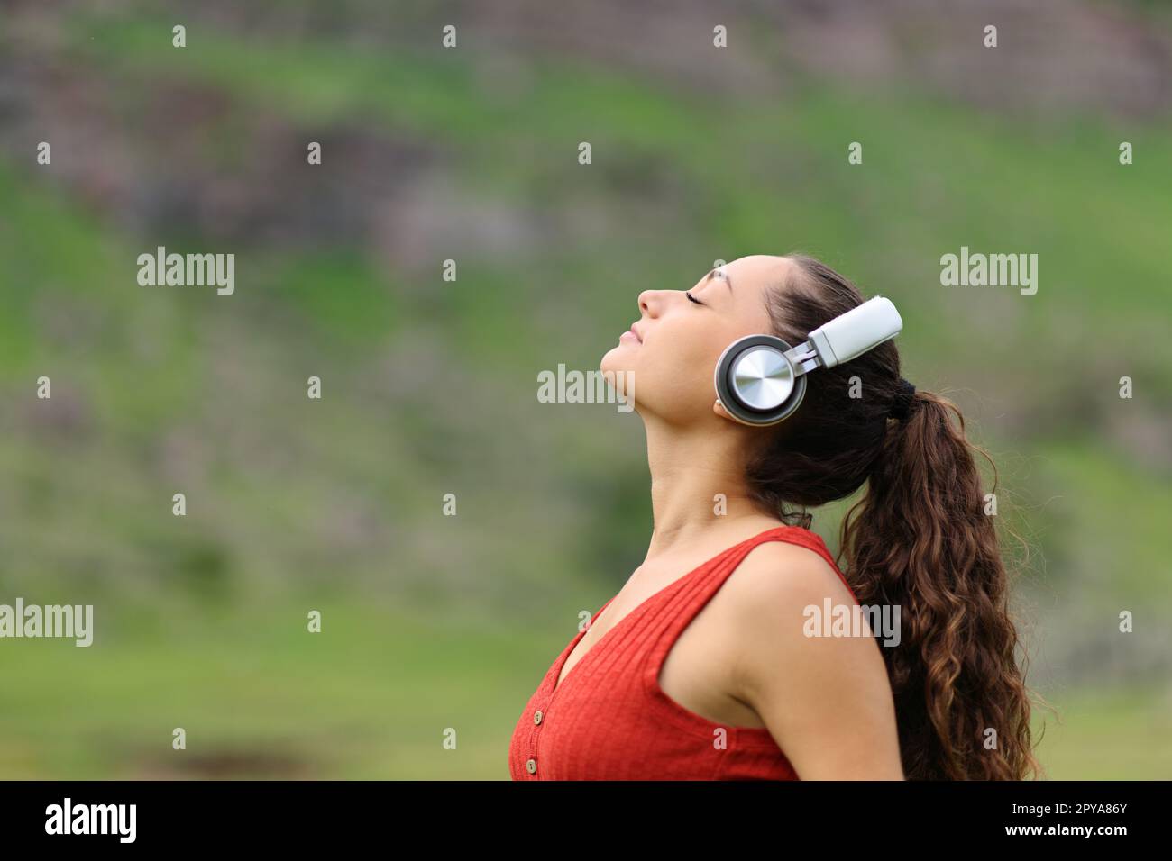 Woman meditating listening audio guide in nature Stock Photo - Alamy