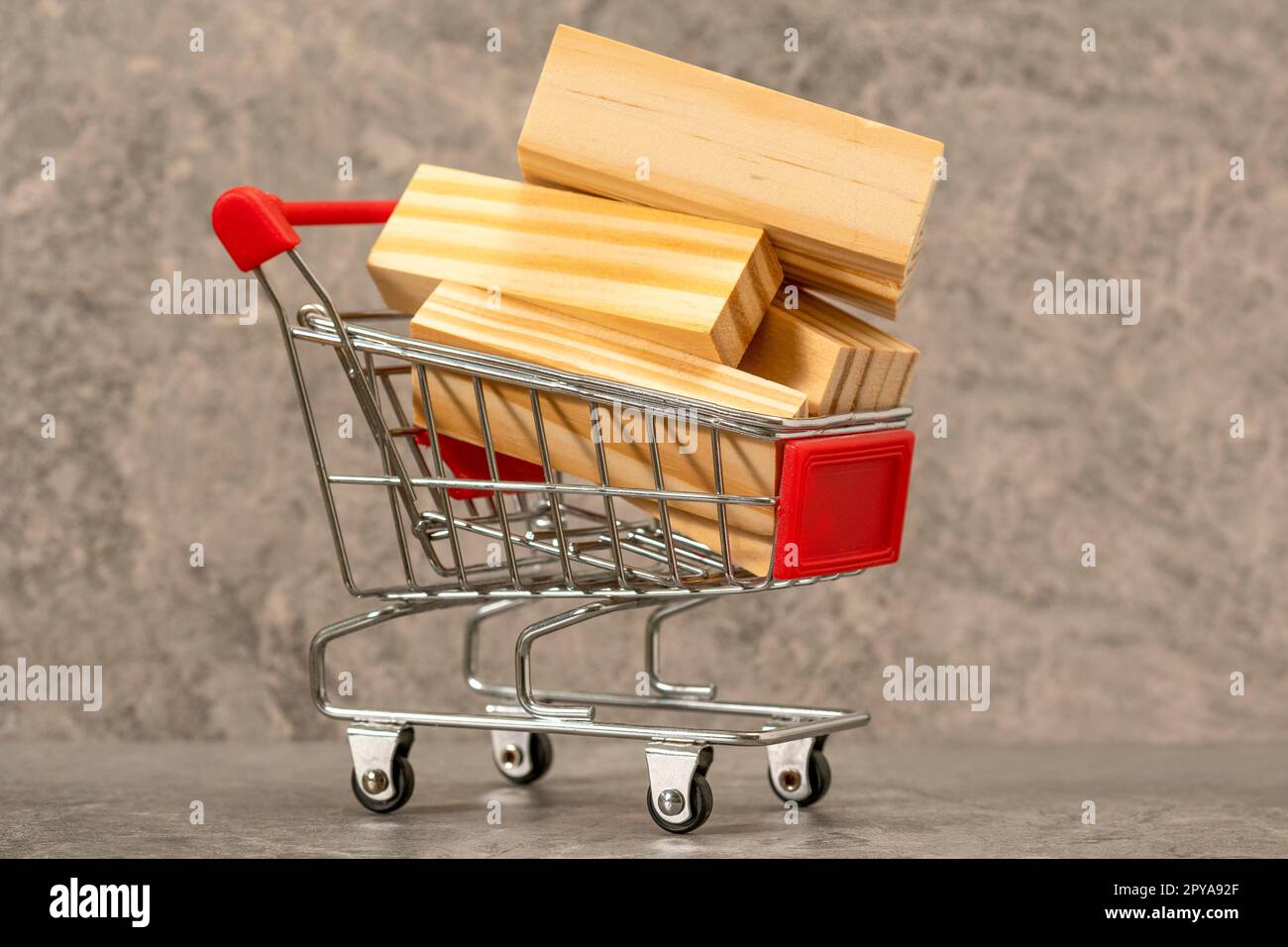 Shopping cart full of wooden blocks Stock Photo - Alamy
