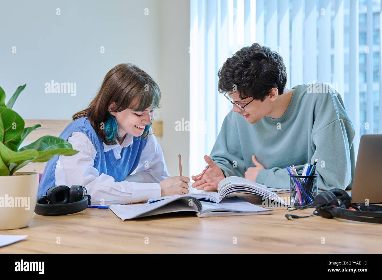 Two teen girl student talk table hi-res stock photography and images ...