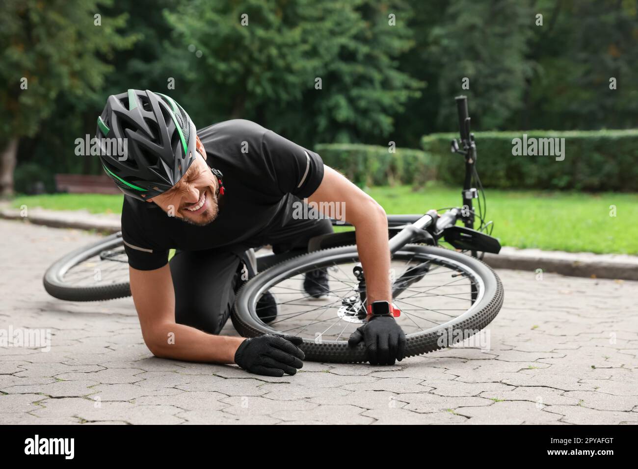 Man fallen off his bike in park Stock Photo - Alamy