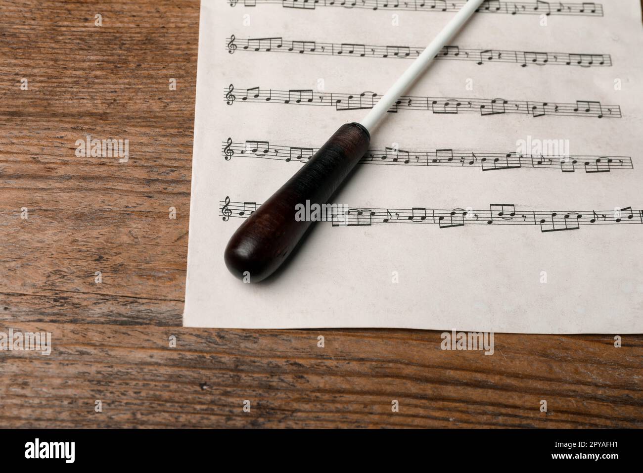 Conductor's baton and sheet music on wooden table, above view Stock ...
