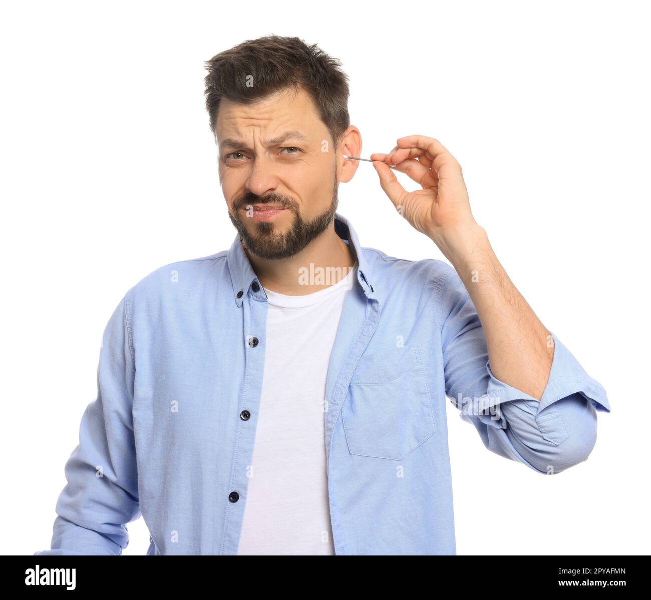 Emotional man cleaning ears on white background Stock Photo - Alamy