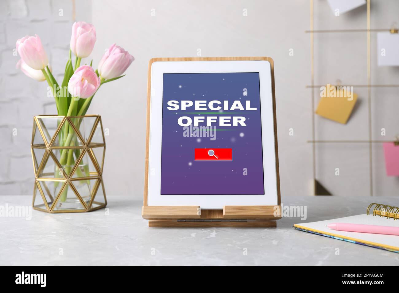 Modern tablet with phrase Special Offer, stationery and flowers on grey ...