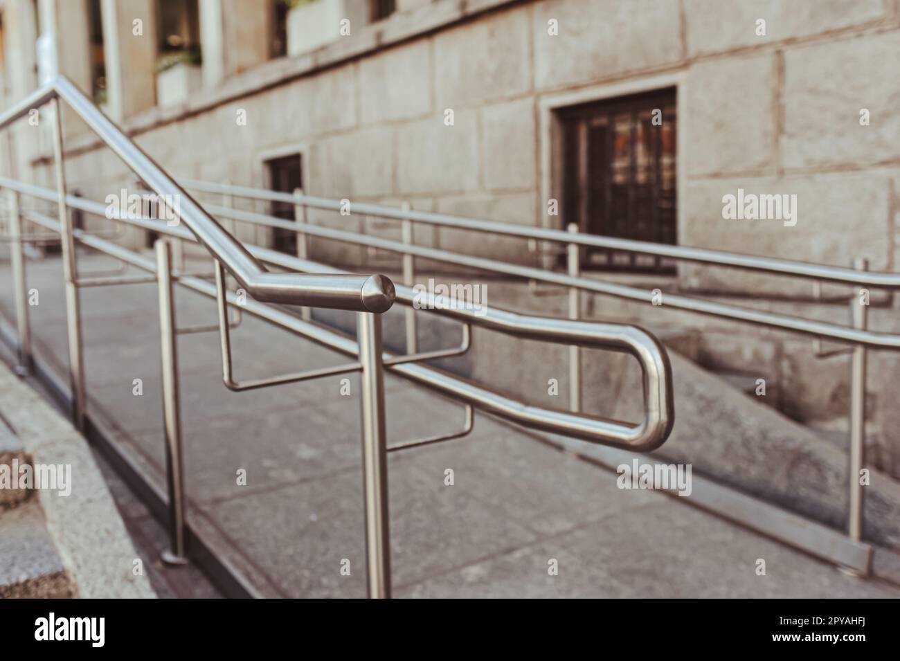 Tiled ramp with shiny metal railings outdoors Stock Photo - Alamy