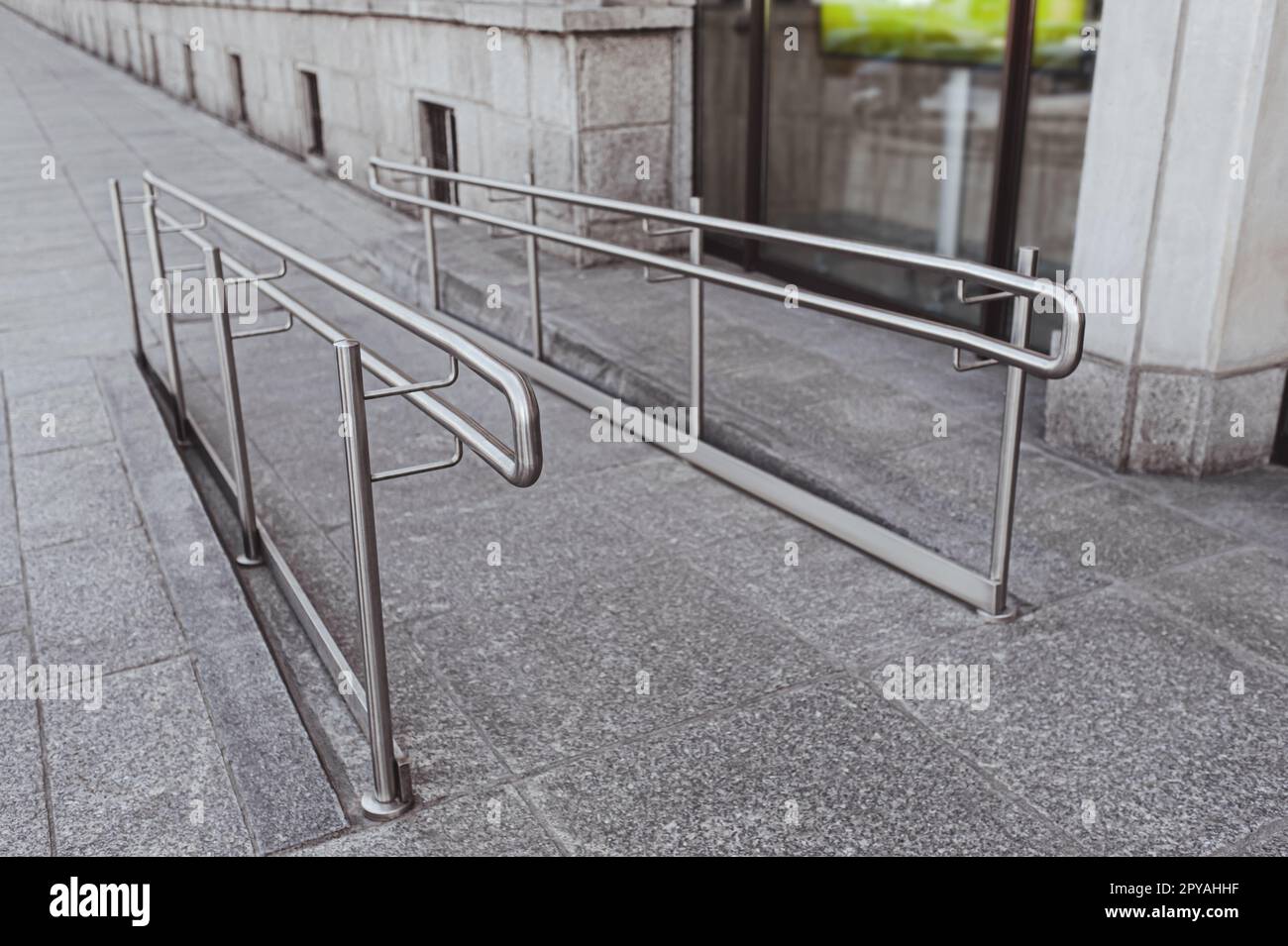 Tiled ramp with shiny metal railings outdoors Stock Photo - Alamy