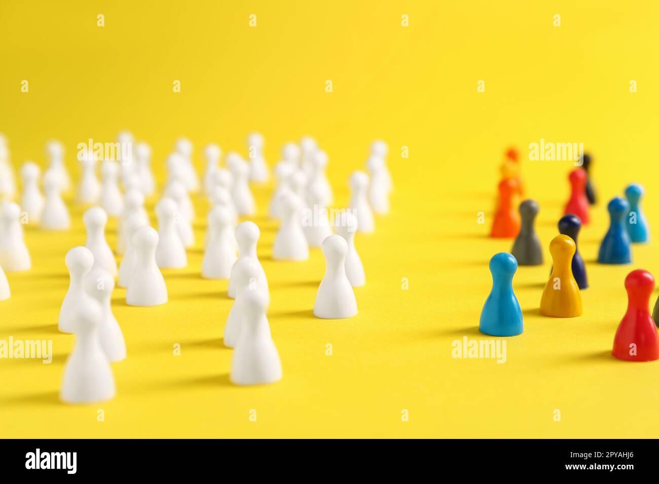 Colorful pawns on yellow background. Social inclusion concept Stock ...