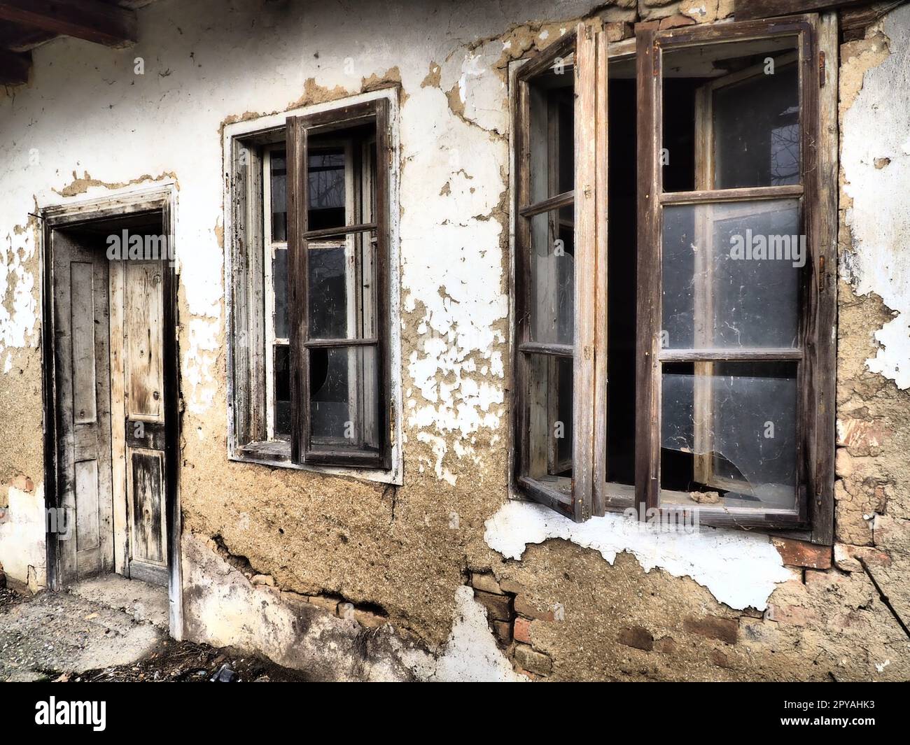 Old house with windows and a door. Collapsing rural house. The concept ...