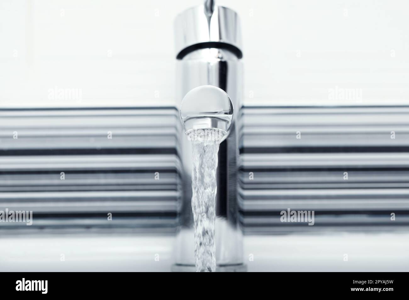 Stream of water flowing from tap in bathroom Stock Photo - Alamy