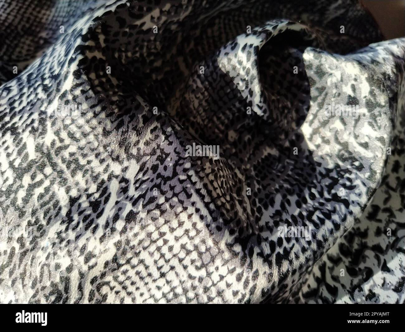 Crumpled silk gray spotted fabric. Pleasant shine of fabric, overflow ...