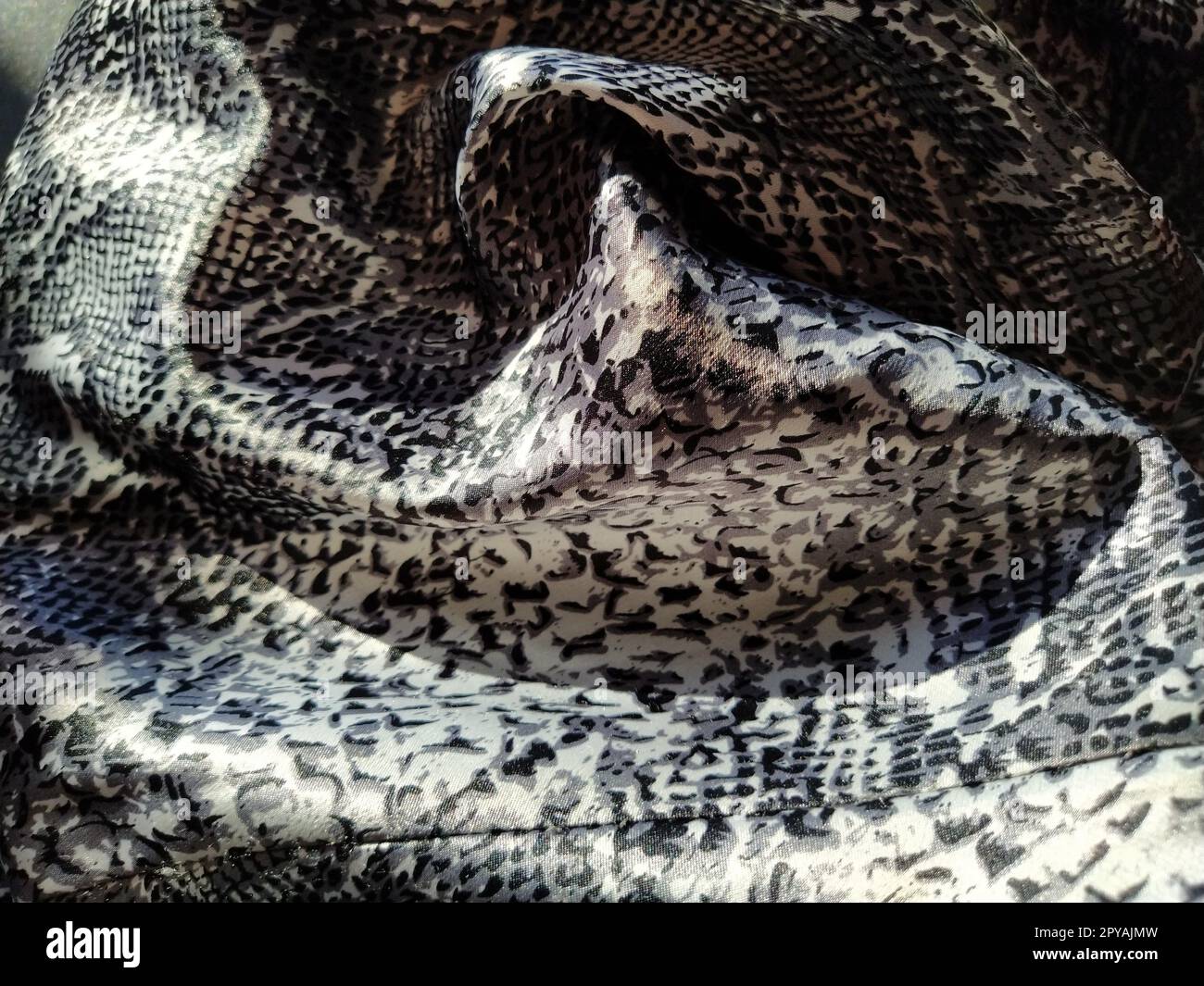 Crumpled silk gray spotted fabric. Pleasant shine of fabric, overflow ...