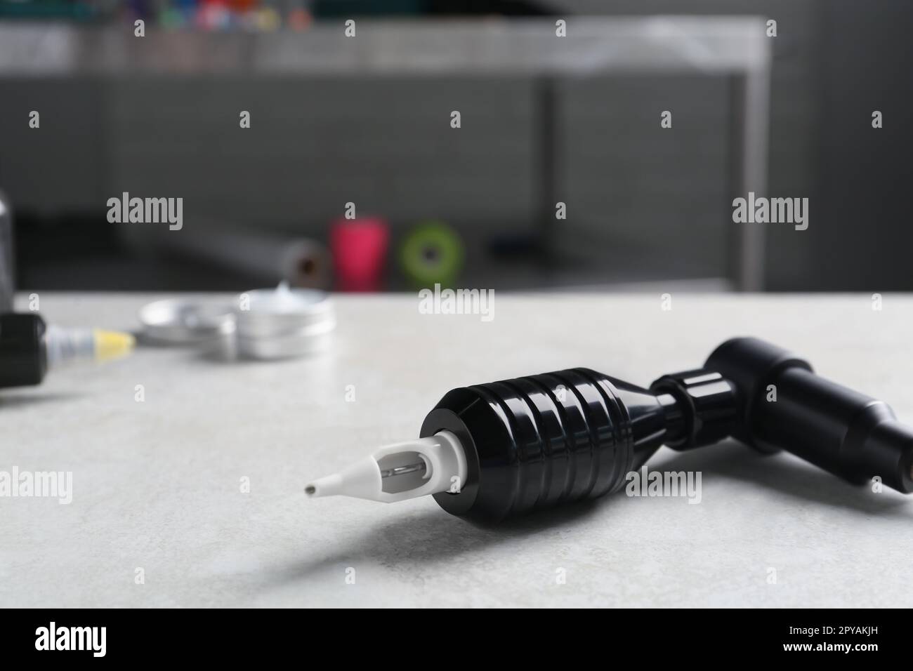 Modern professional tattoo machine on white table in salon Stock Photo ...