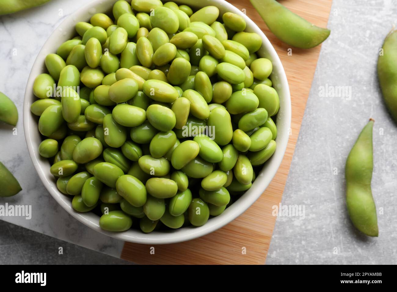 Organic edamame beans on light grey table, flat lay Stock Photo - Alamy