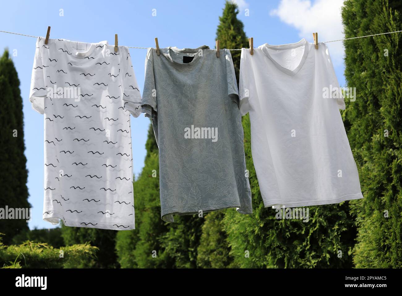 Washing line with clean clothes in garden. Drying laundry outside Stock ...