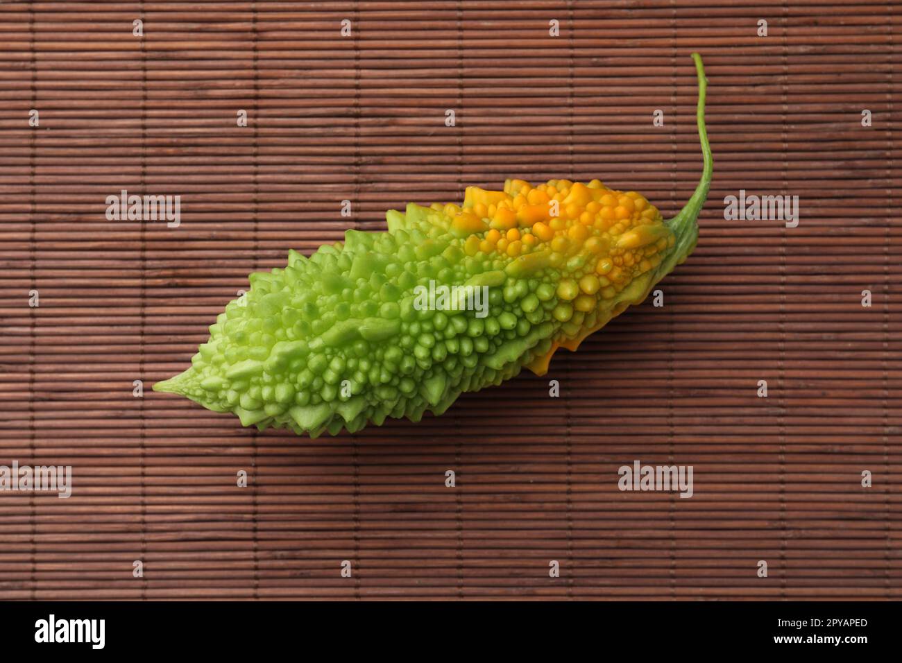 Fresh bitter melon on bamboo mat, top view Stock Photo - Alamy