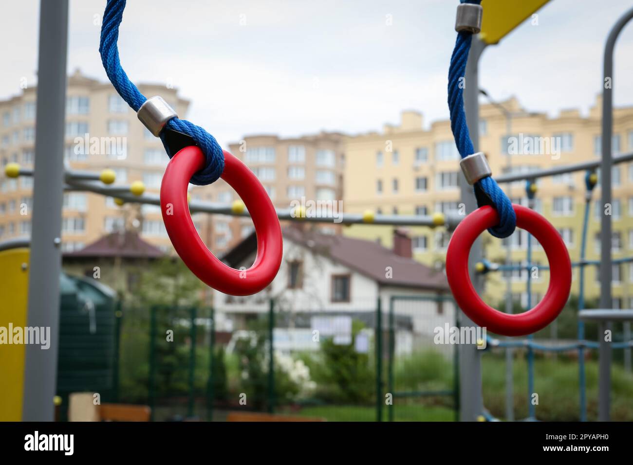 Gymnastic rings on outdoor playground in residential area Stock Photo ...