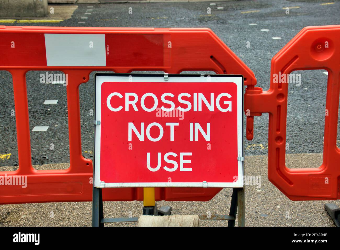 crossing not on use sign with barrier Stock Photo - Alamy