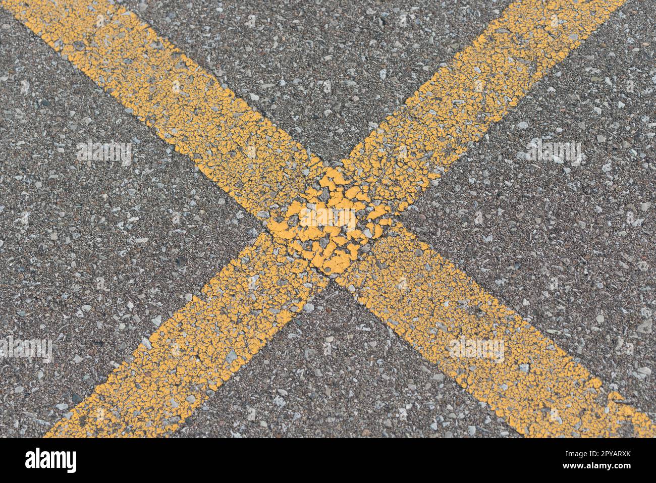 close up of meeting point between two parking lot lines on an asphalt ...
