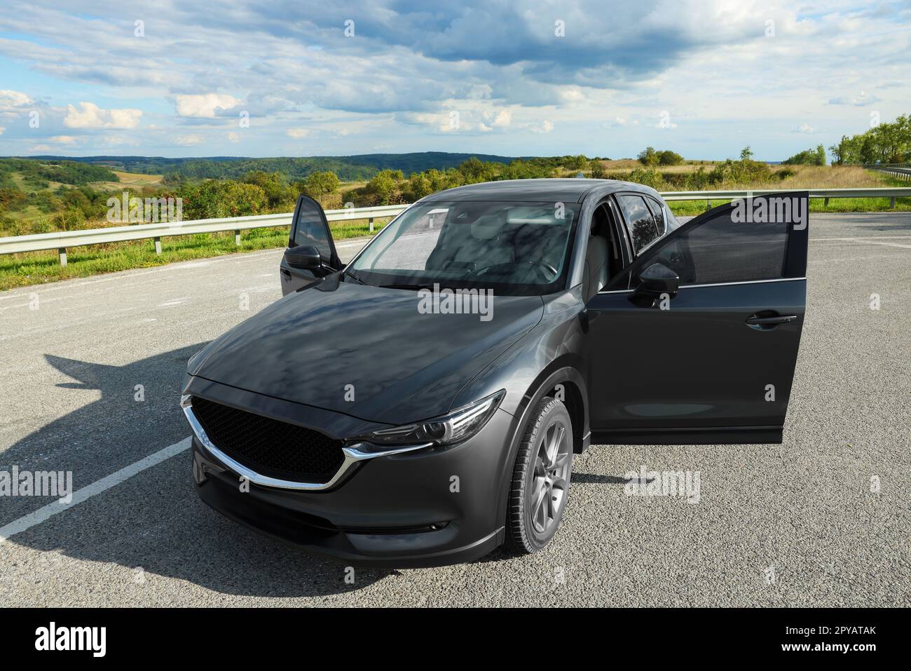 New black modern car with open doors on asphalt road Stock Photo - Alamy