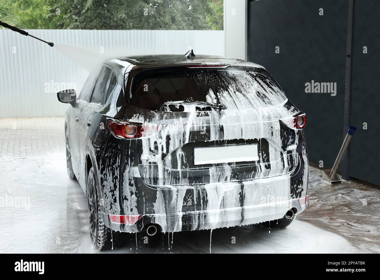 Washing auto with high pressure water jet at outdoor car wash Stock ...