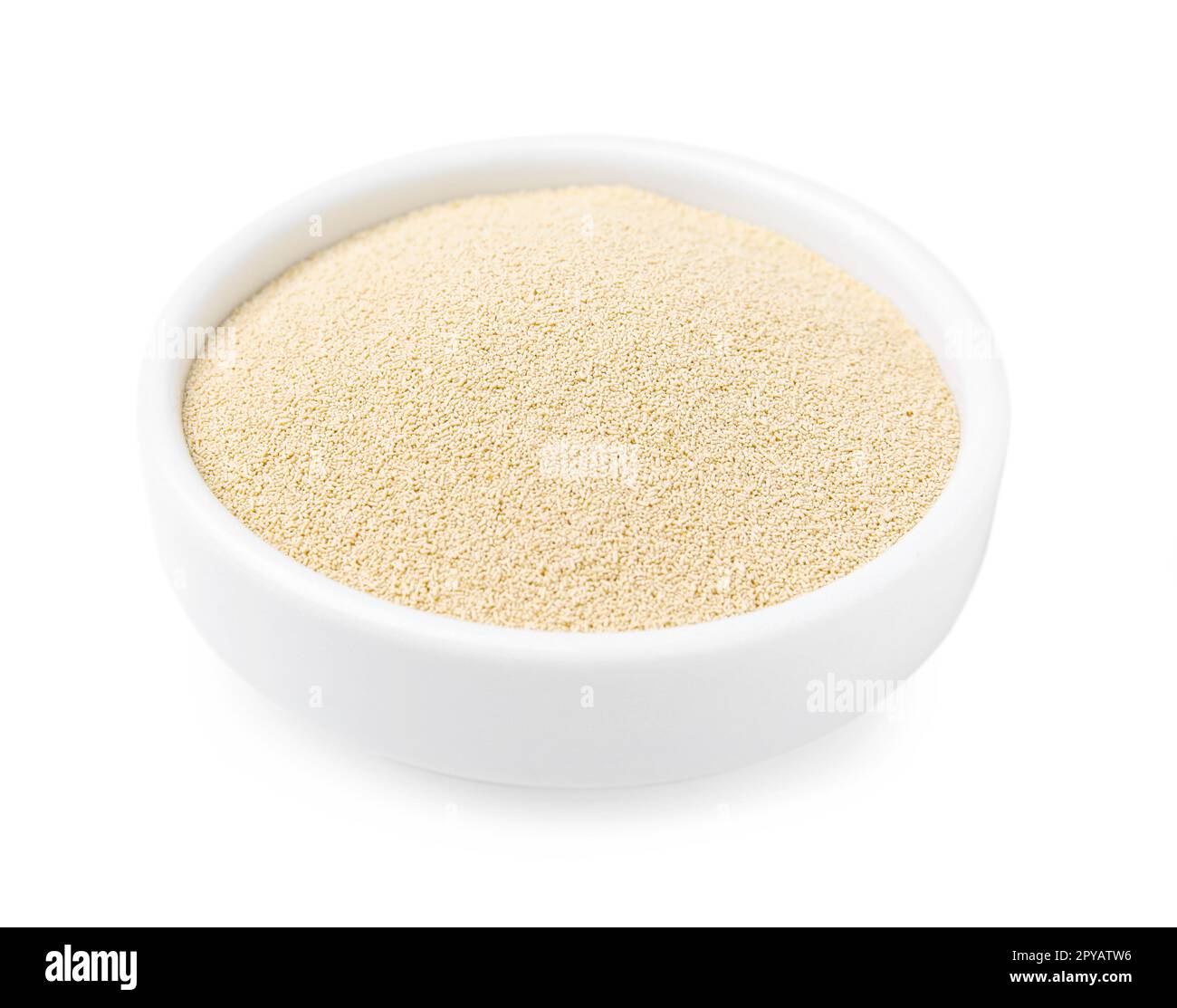 Granulated yeast in bowl on white background Stock Photo - Alamy