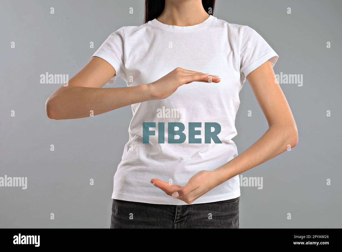 Woman holding hands near belly and word Fiber, closeup Stock Photo - Alamy