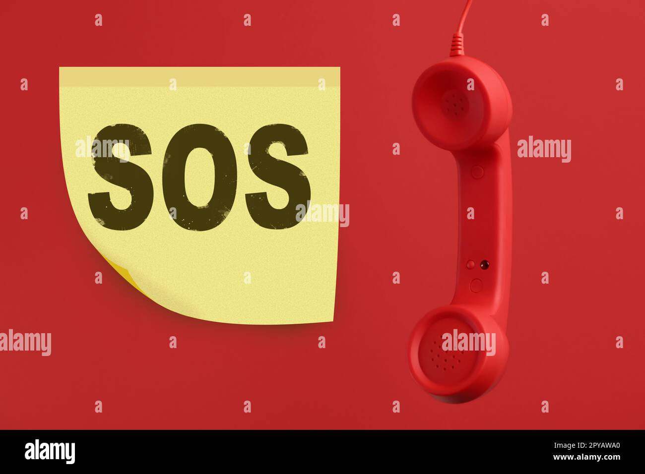 Telephone handset on red background. Emergency SOS call Stock Photo - Alamy