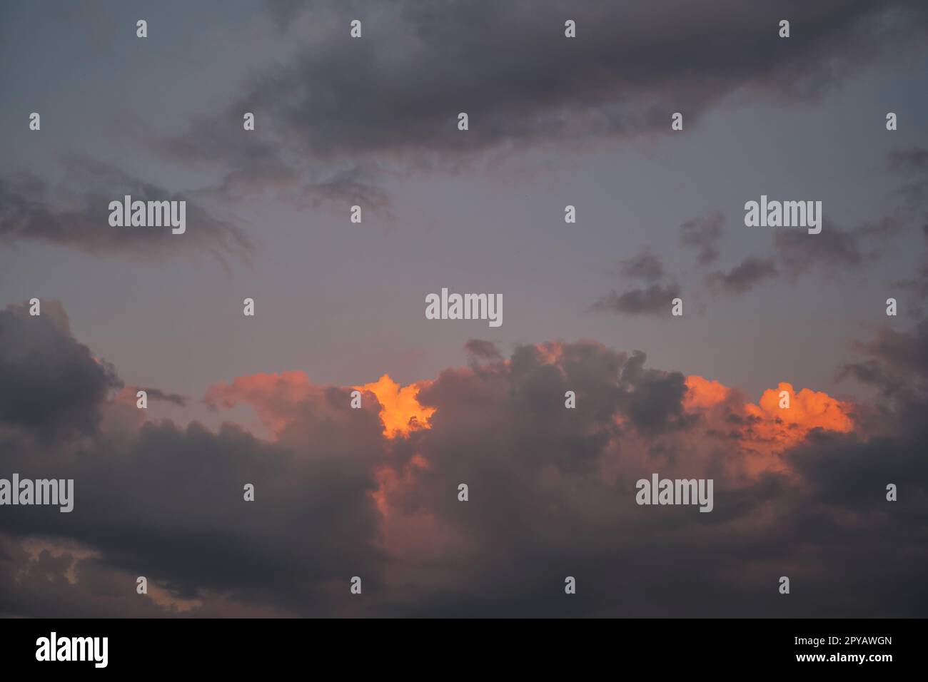 Dramatic clouds lit by the sun on a dramatic sunset sky. Selective ...