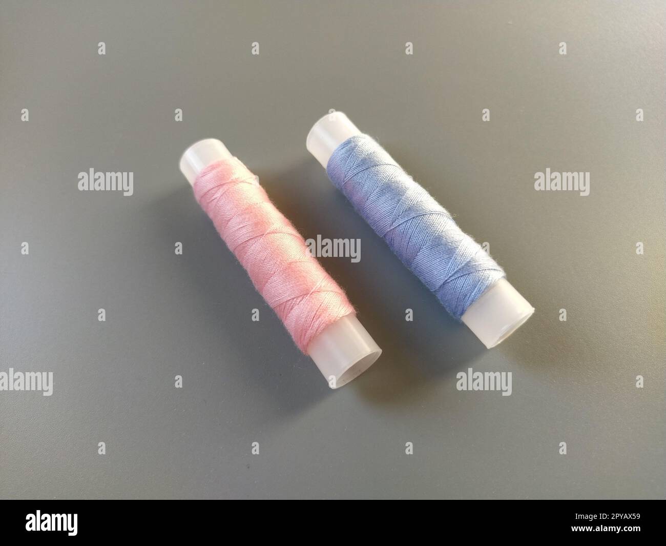 Blue yellow spools thread hi-res stock photography and images - Alamy