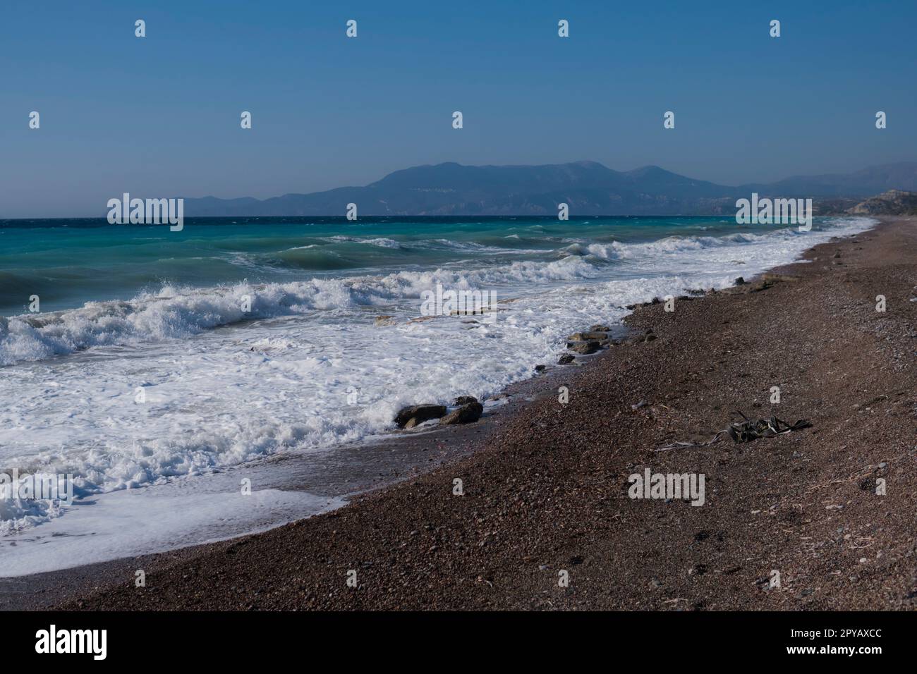 East shore of Rhodes Island with big waves and rocky beach Stock Photo ...