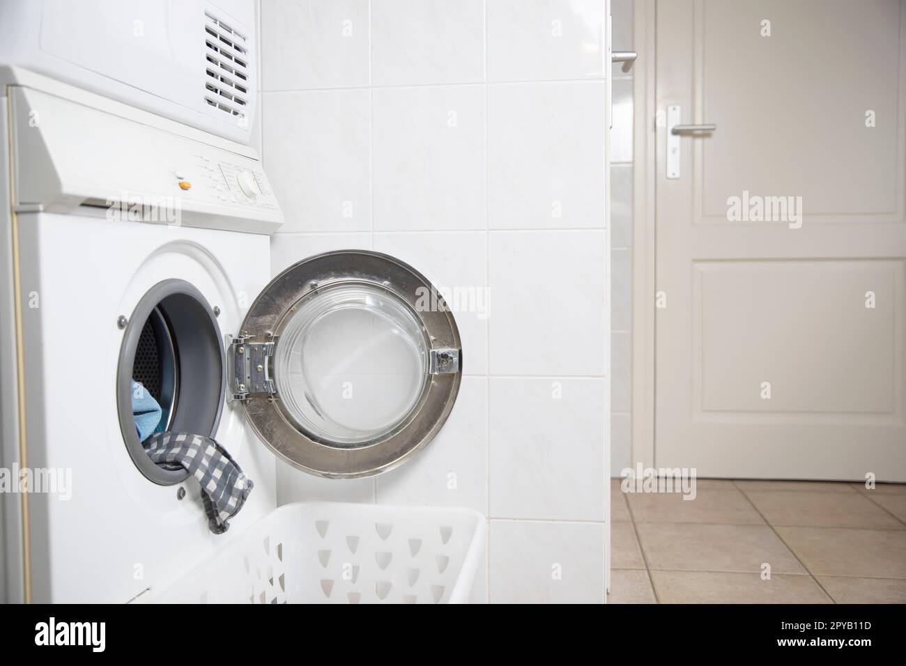 Laundry concept. white and modern washing machine with open door ...
