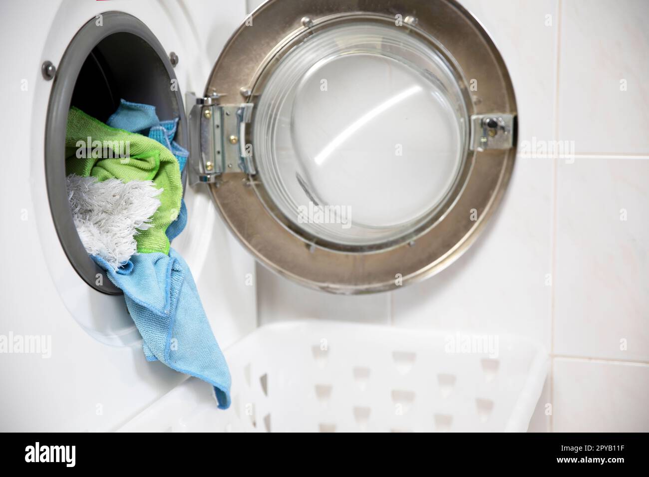 Laundry concept. white and modern washing machine with open door ...