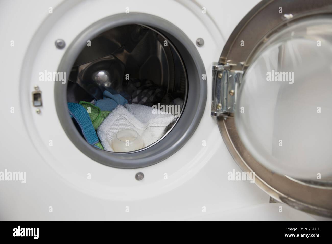 Laundry concept. white and modern washing machine with open door ...