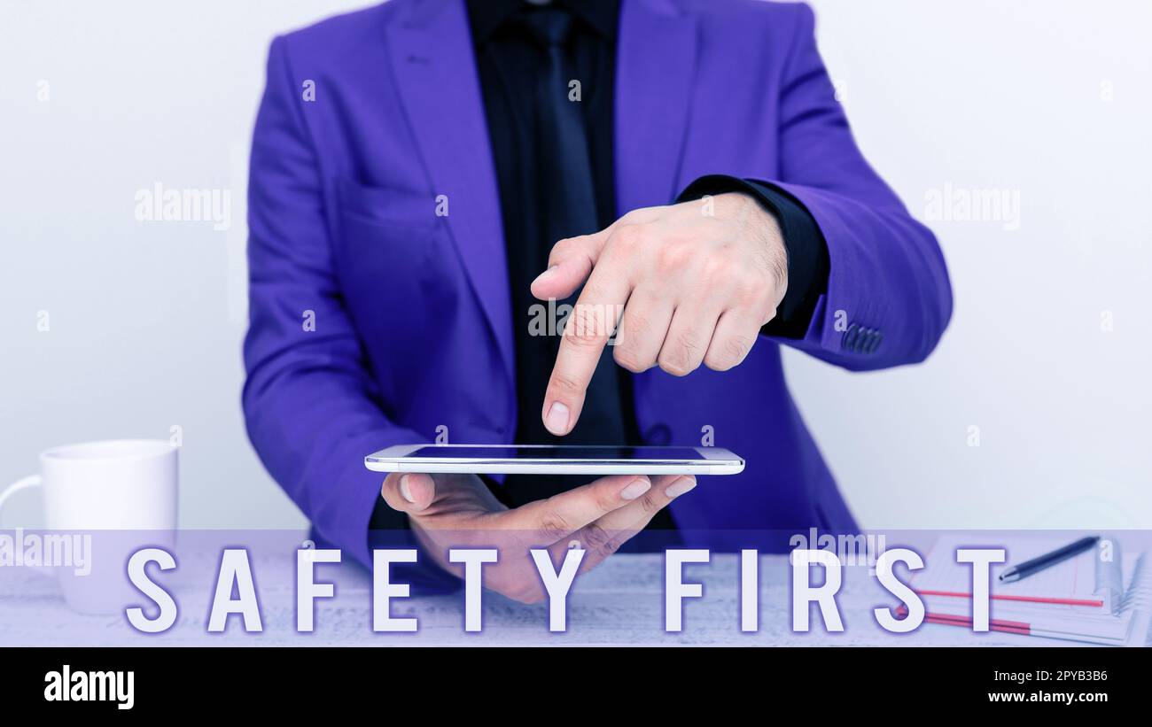 Hand writing sign Safety First. Word for Avoid any unnecessary risk ...