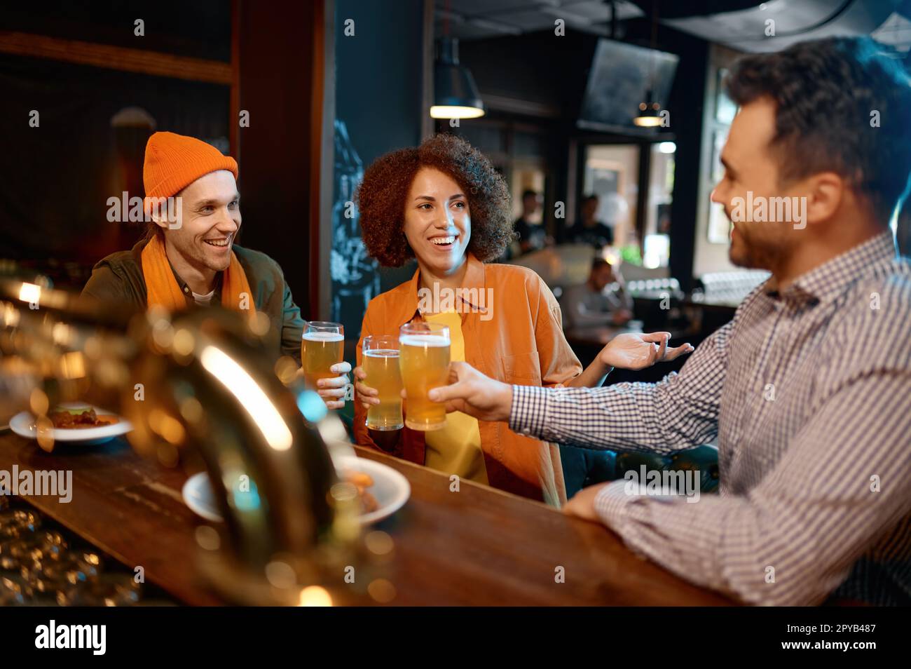 Happy diverse group friends drinking hi-res stock photography and ...