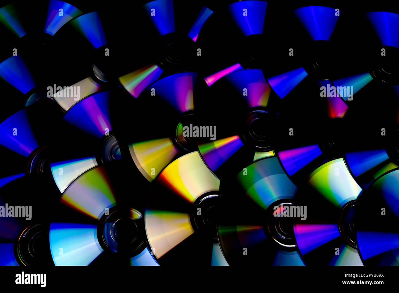 CD and DVD isolated on black background with colorful light reflections ...