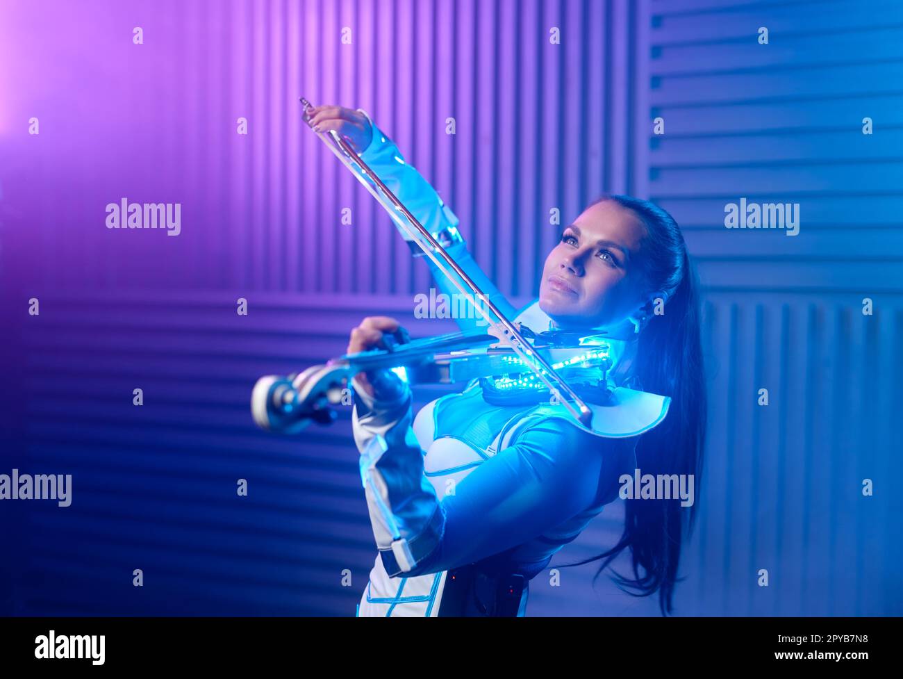 Portrait of violin solo player on stage in neon light Stock Photo - Alamy